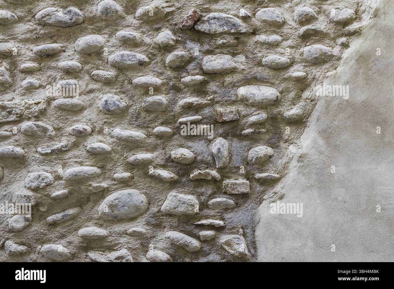Stone walls partially covered by plaster Stock Photo - Alamy
