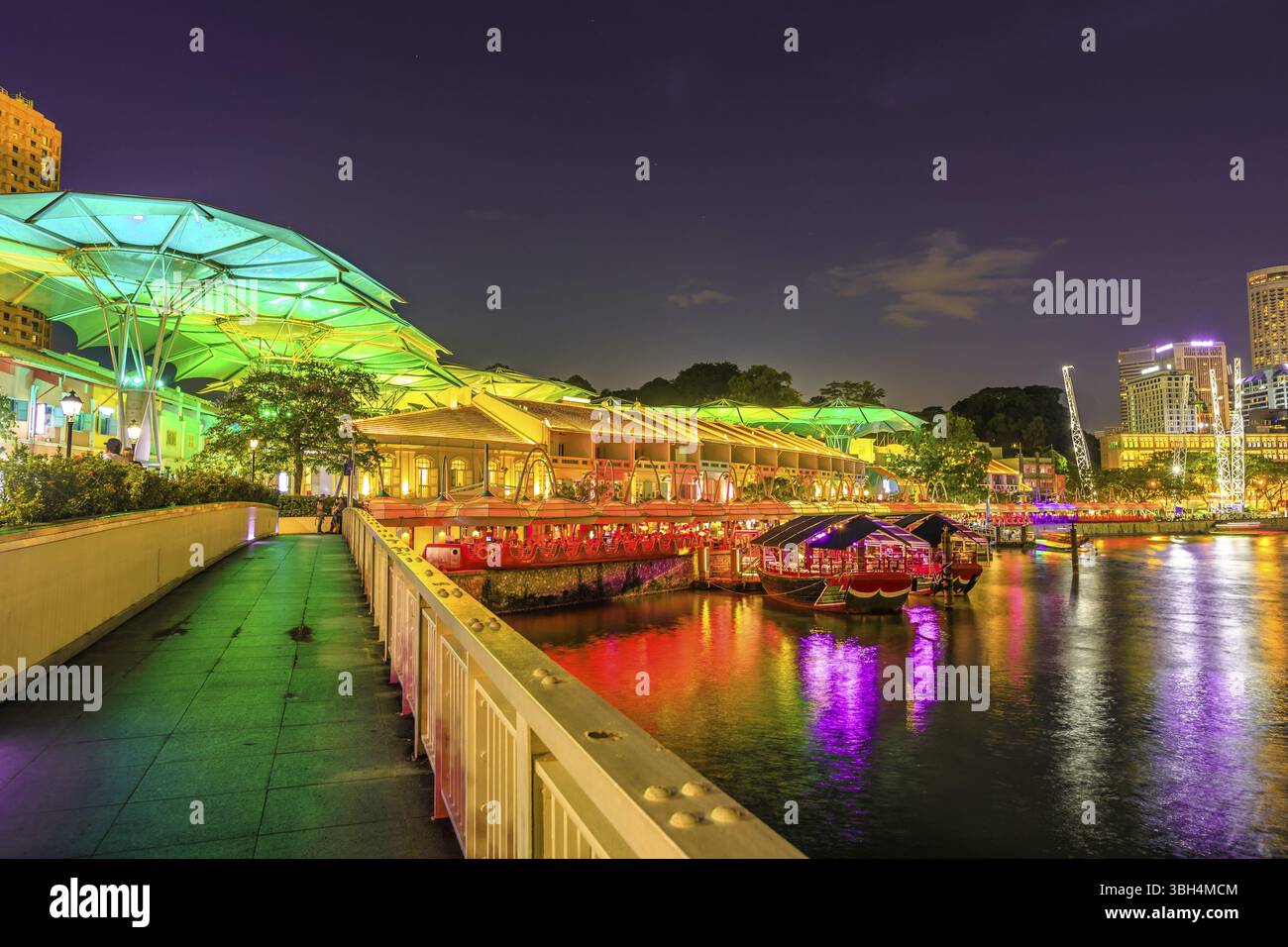 Clarke Quay bridge and Riverside area at evening in Singapore ...