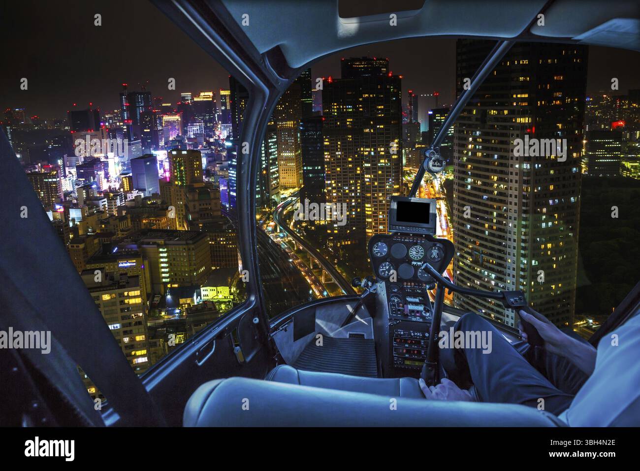 Helicopter flying over Tokyo cityscape and Shiodome skyscrapers and ...