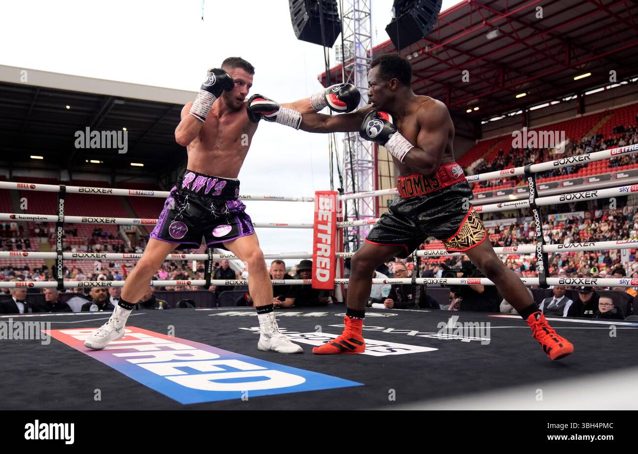 Rhys Edwards (left) in action against Thomas Essomba (right) at Oakwell ...