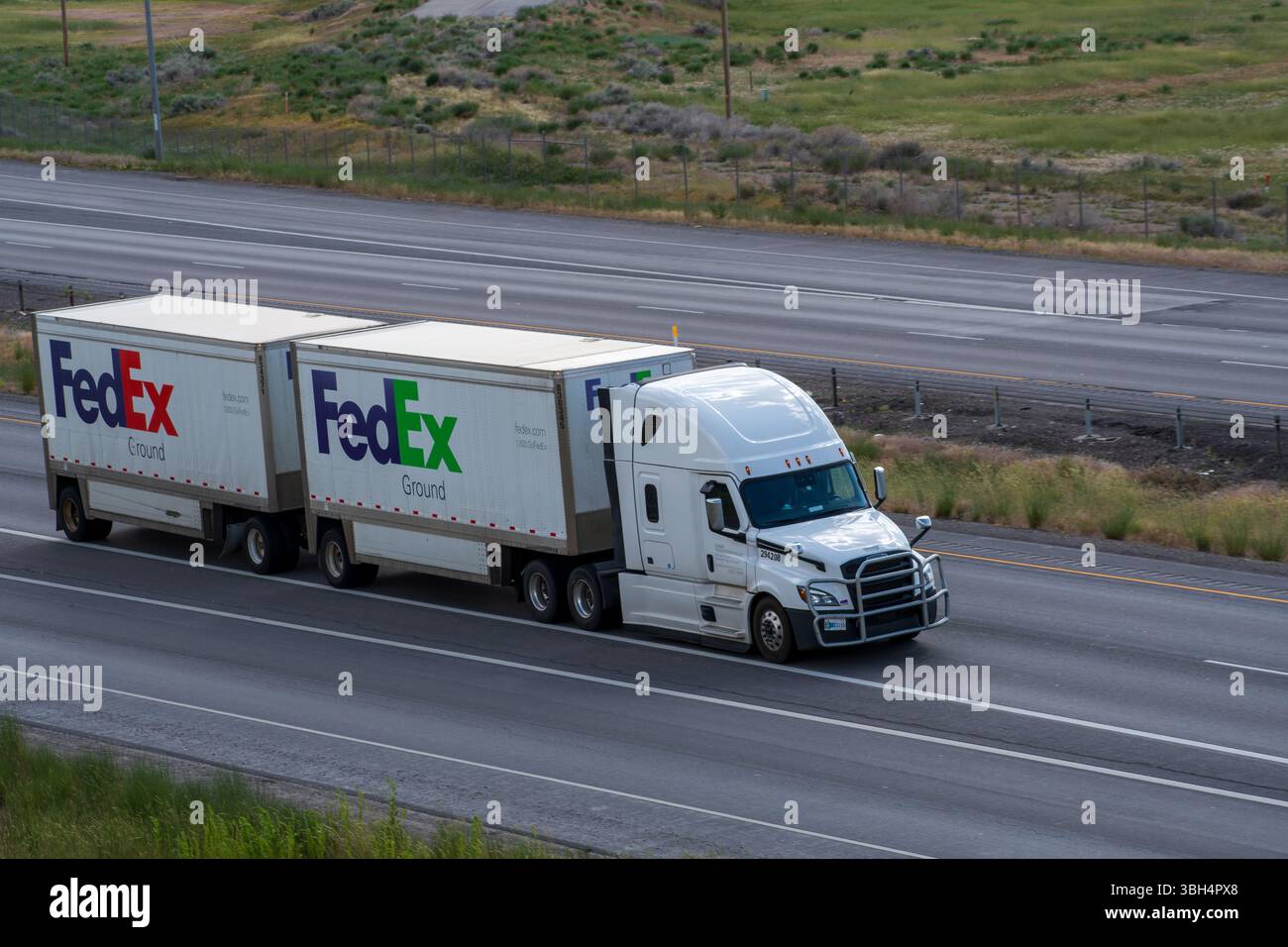 SANTAQUIN, UT – JUNE 8, 2025: FedEx truck on empty I-15 hauls two ...