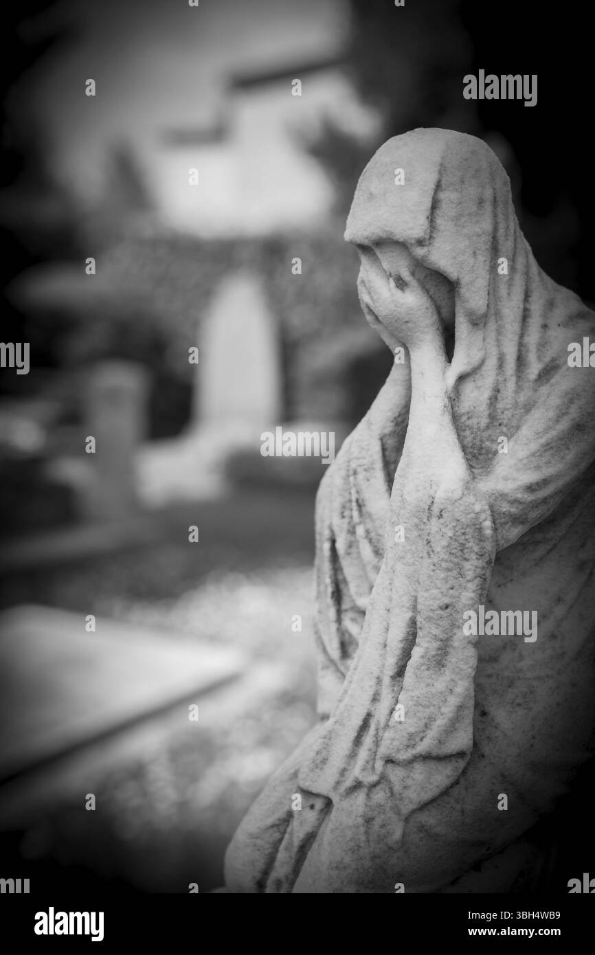 Statue of a desperate woman. Defocused blurry background Stock Photo ...