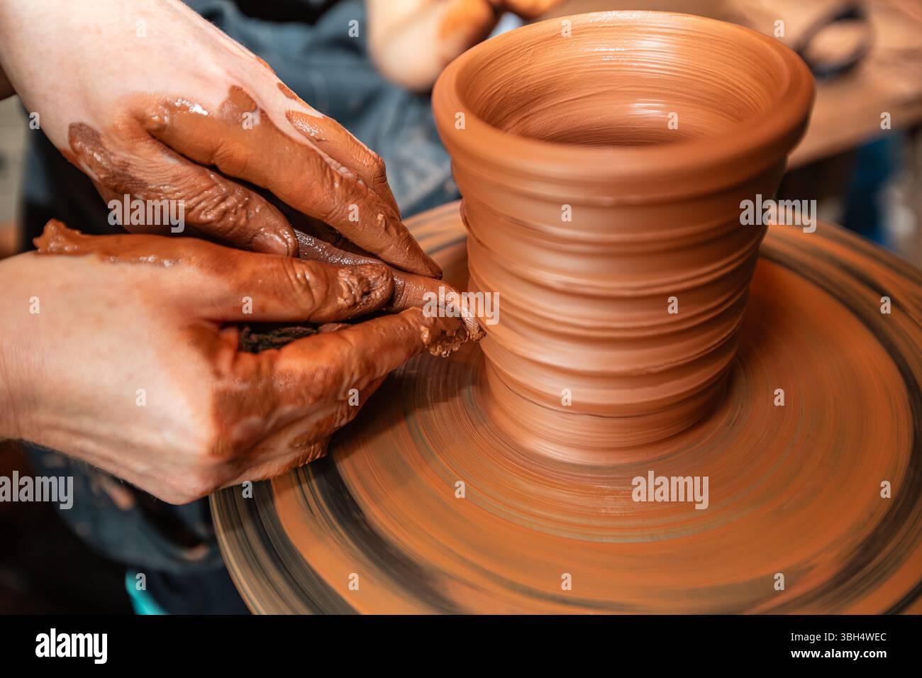 Hands of Adult and Child Making Pottery on Wheel Stock Photo - Alamy