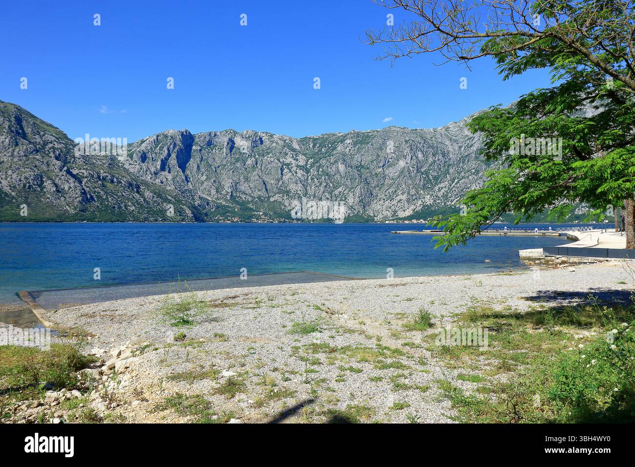 A shingle beach and the Bay of Kotor Stock Photo - Alamy