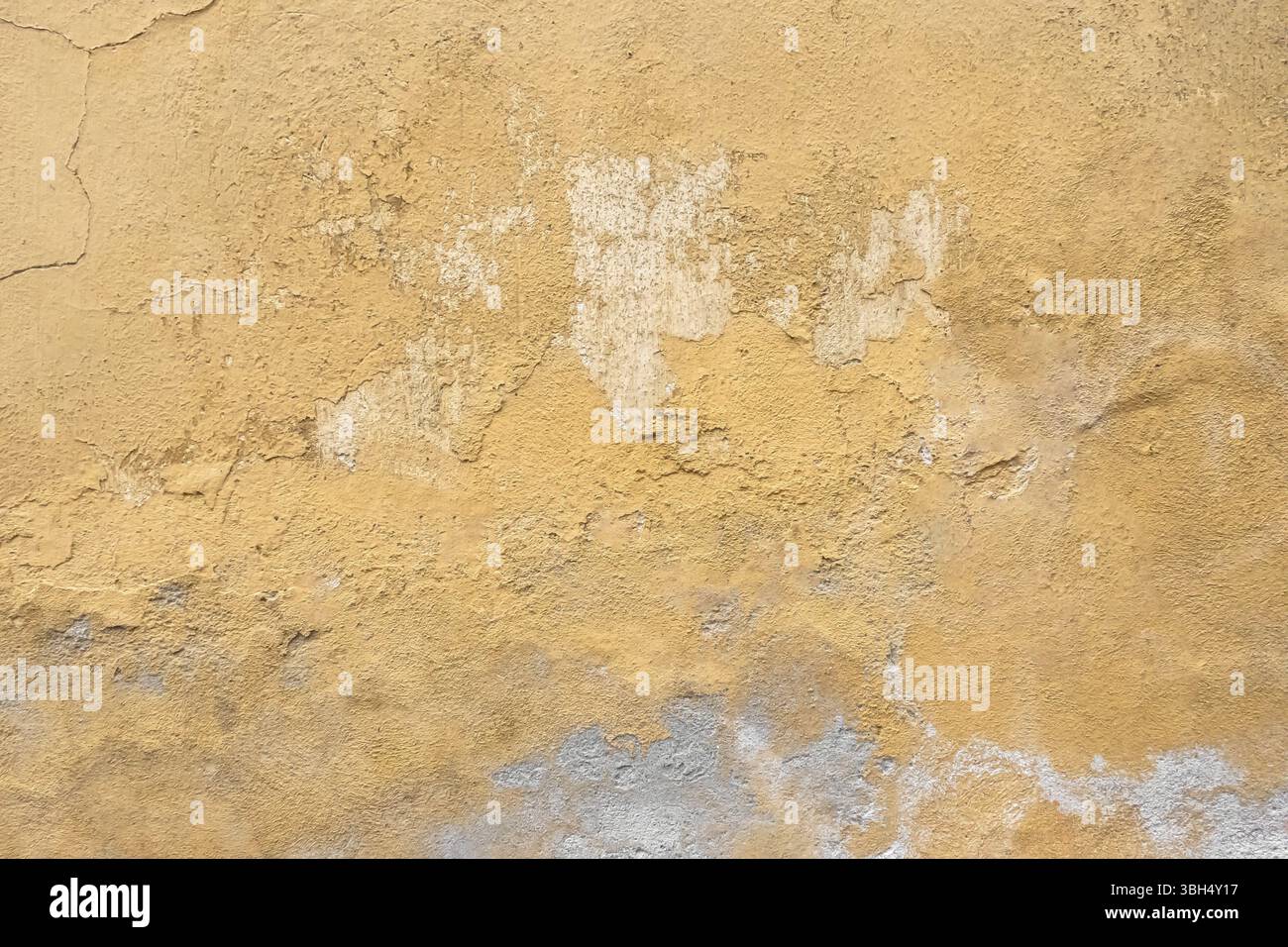 Grunge plaster wall with yellow scratched background. Old wall with ...