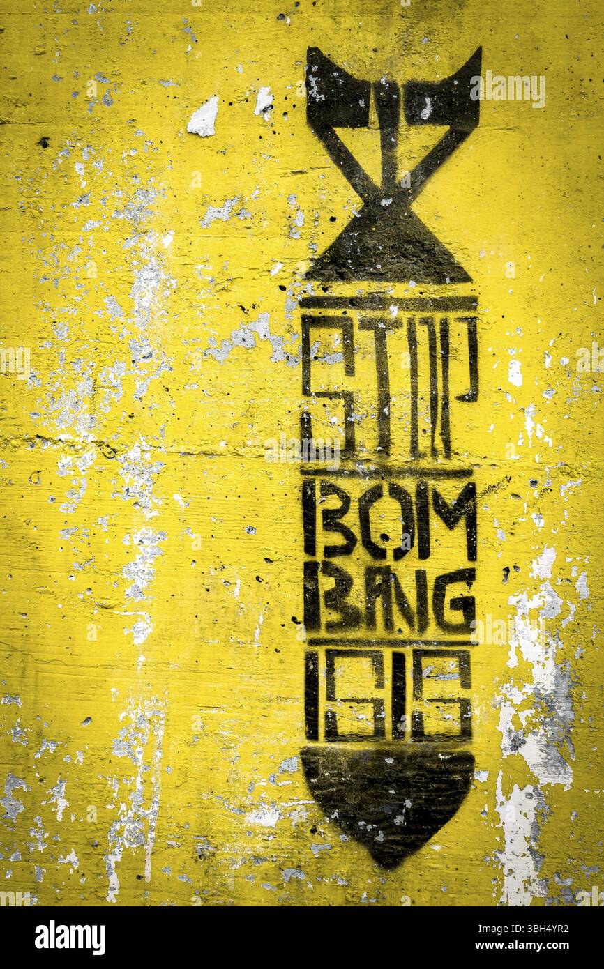 Graffiti on the wall depicting the silhouette of a bomb. Inside the message STOP ISIS. It can be ...