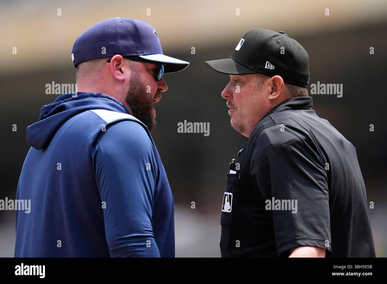 Toronto Blue Jays manager John Schneider, left, talks with home plate ...