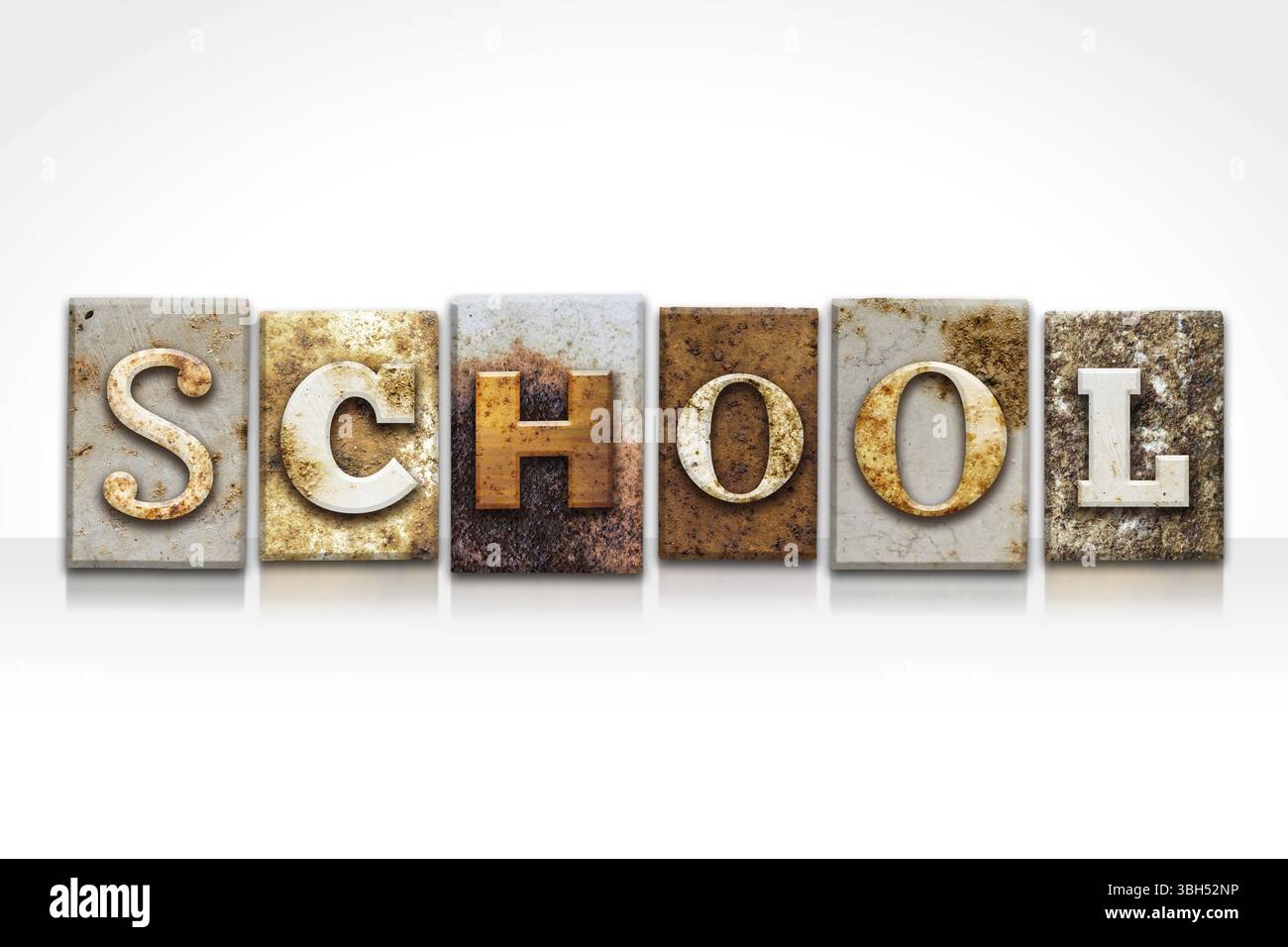 The word SCHOOL written in rusty metal letterpress type isolated on a ...