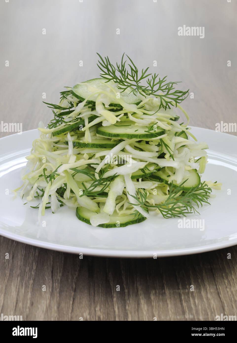 Salad finely chopped cabbage with cucumber and dill Stock Photo - Alamy
