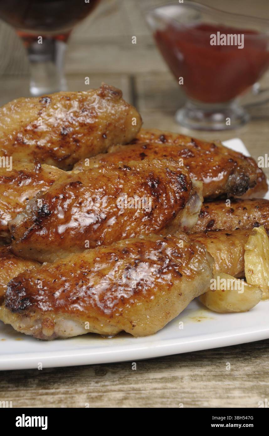 Fried sharply spicy chicken wings on a baking c sauce Stock Photo - Alamy