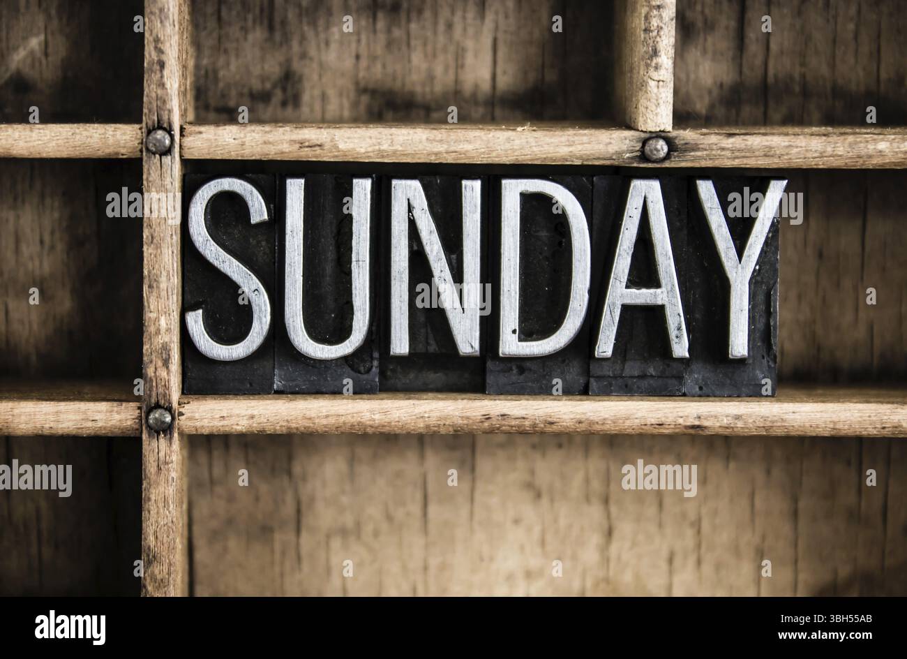 The word SUNDAY written in vintage metal letterpress type in a wooden ...
