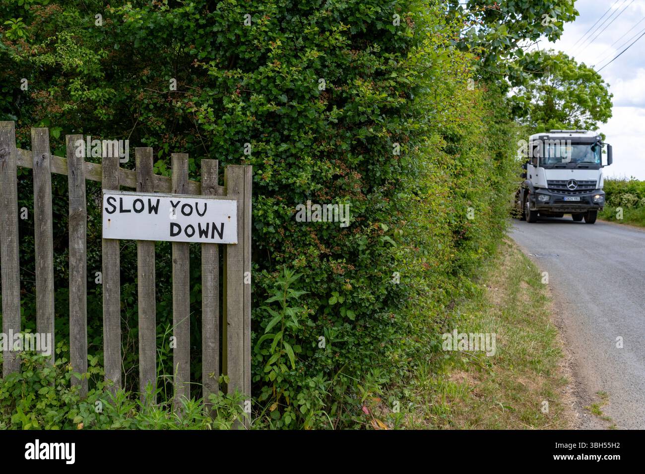 Slow you down hand written roadside sign Stock Photo - Alamy