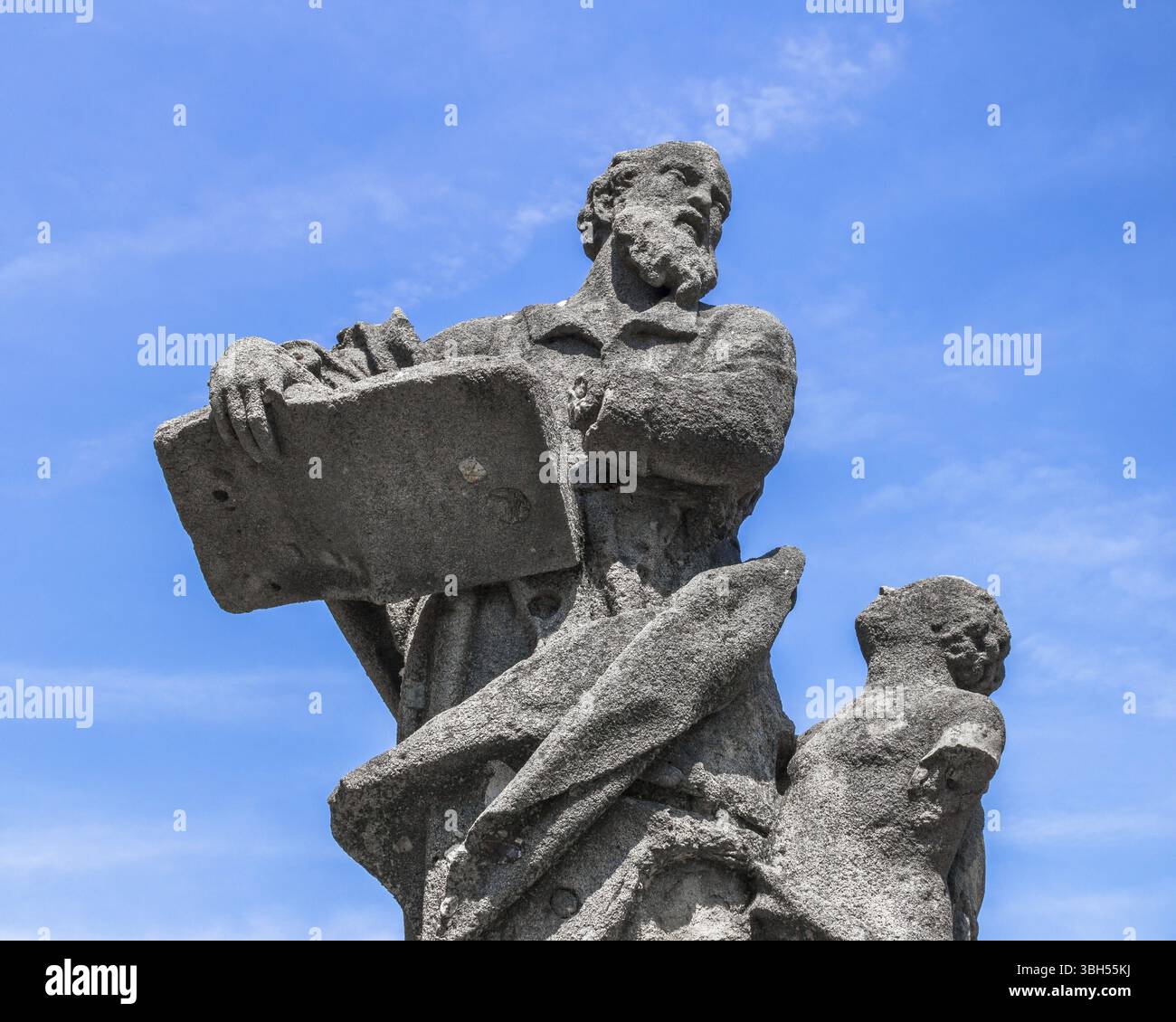 Statue of an old teacher with mutilated hand and his student Stock ...