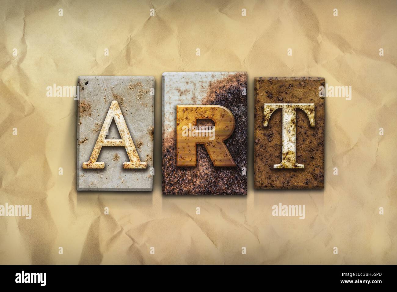 The word ART written in rusty metal letterpress type on a crumbled aged ...