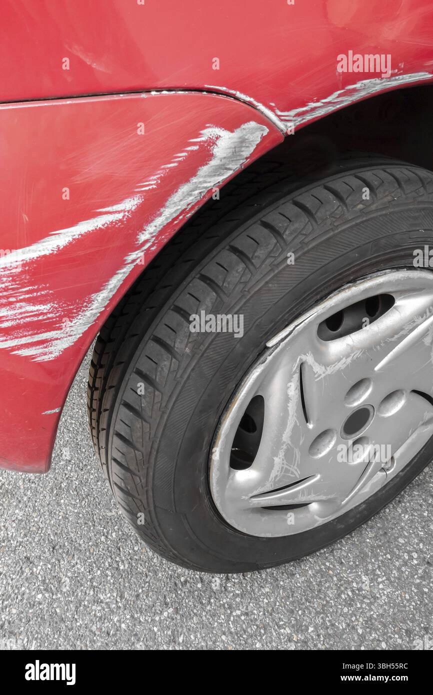 Car body damage. Dents and scratches on the red car paint Stock Photo ...