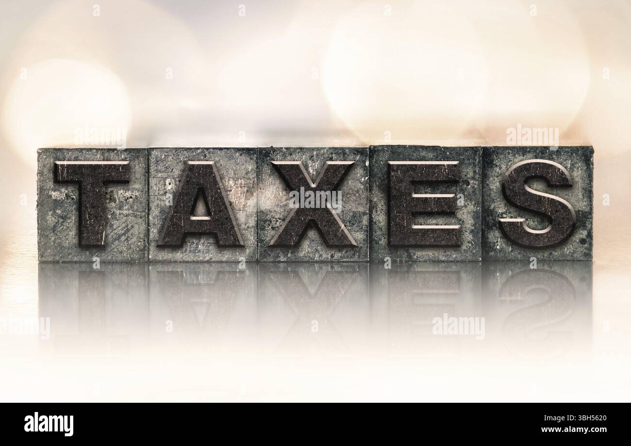 The word TAXES written in vintage ink stained letterpress type Stock ...