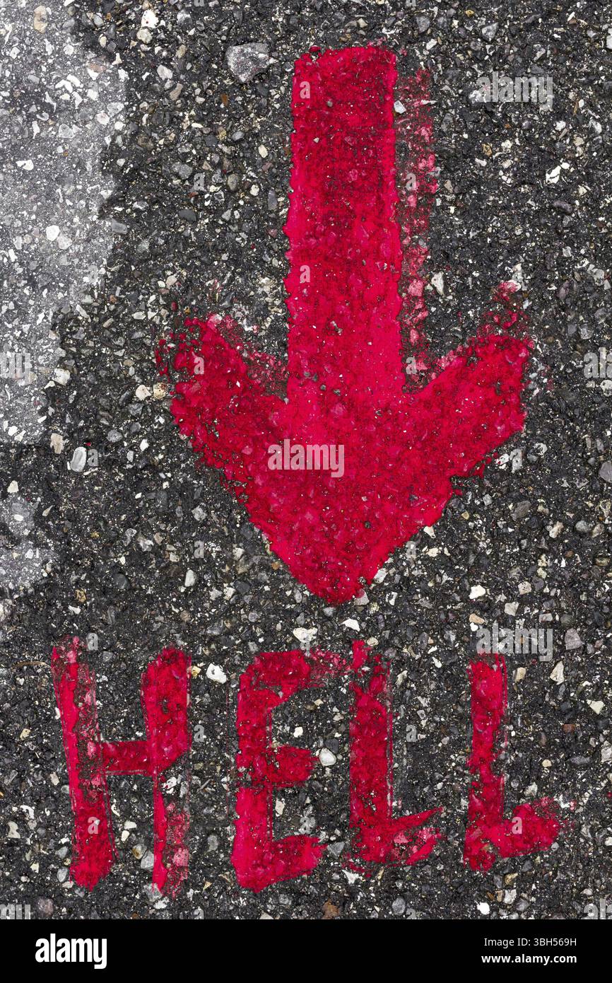 A red arrow painted on the asphalt showing the direction to hell Stock ...