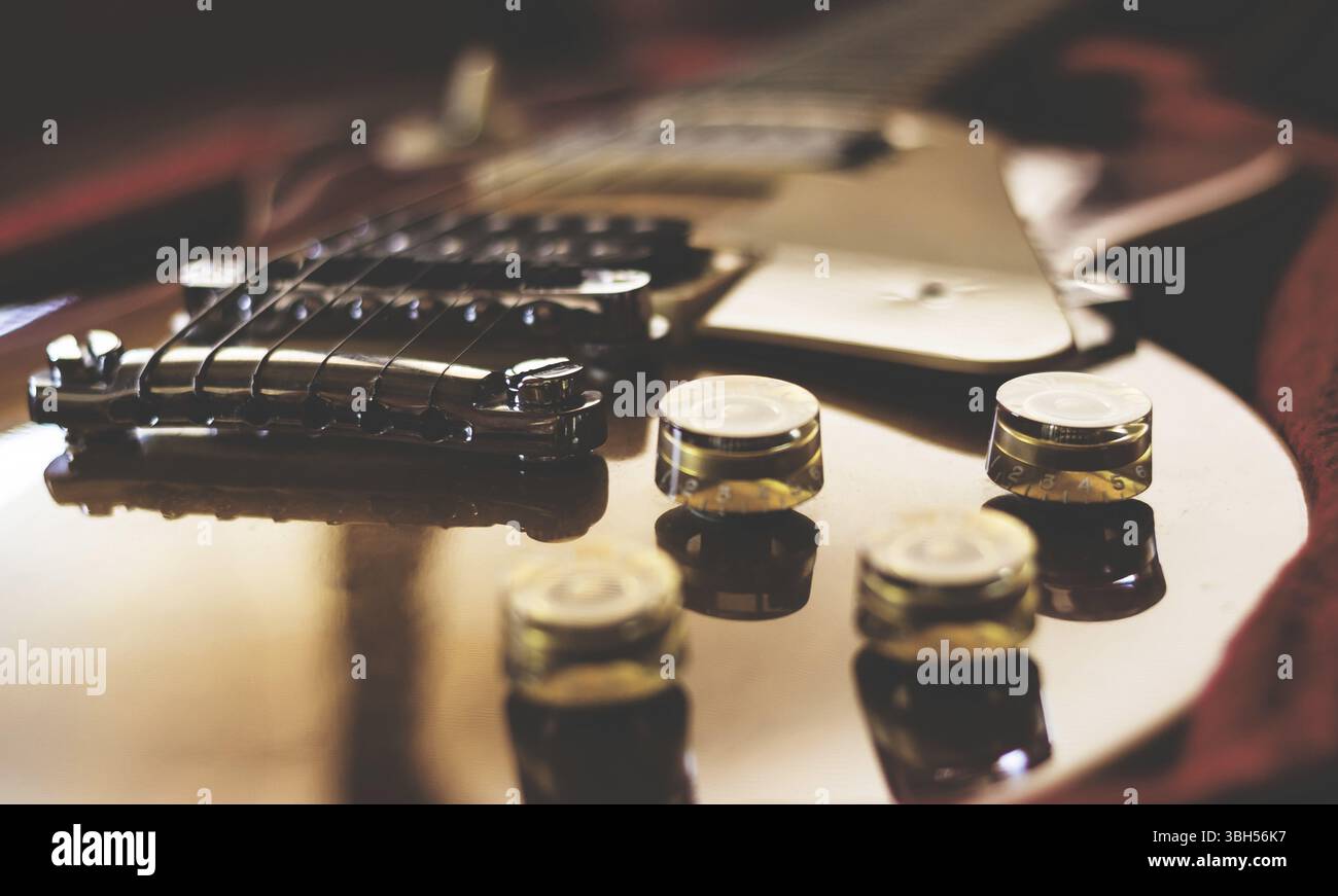 Close-up of an electric guitar laying inside a guitar case. Retro style ...