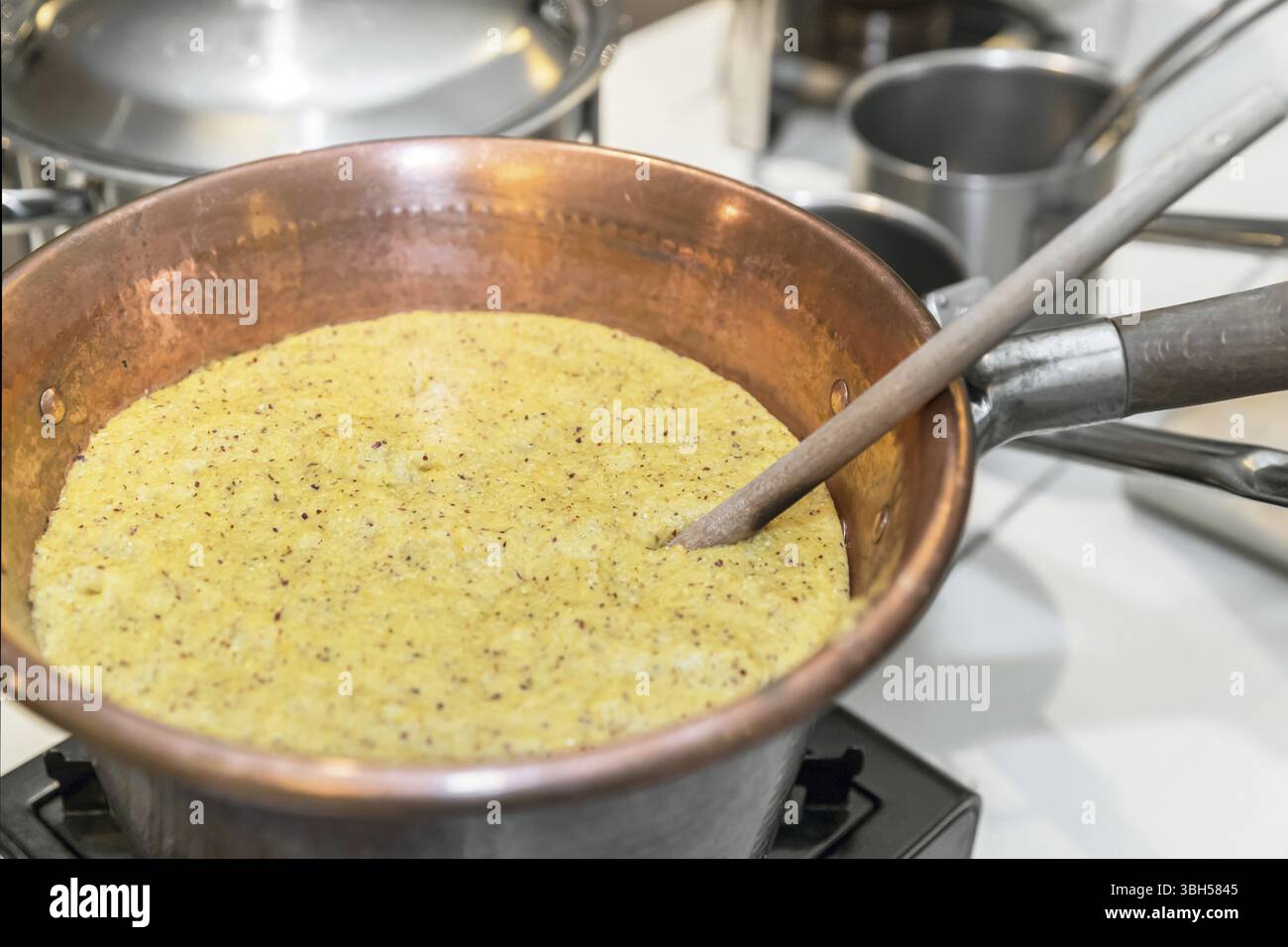Polenta. Typical dish from Bergamo cooked in the traditional copper pot ...