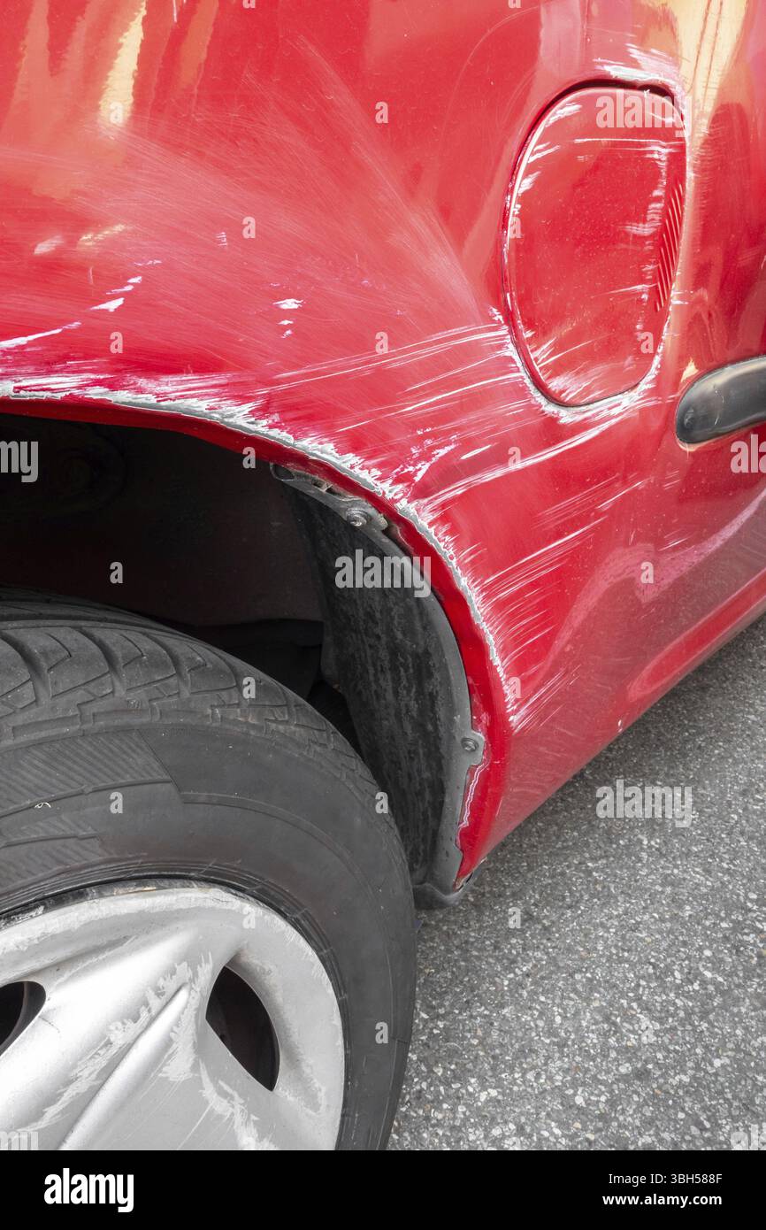 Generic red car with scratched paint and dented body in crash accident ...