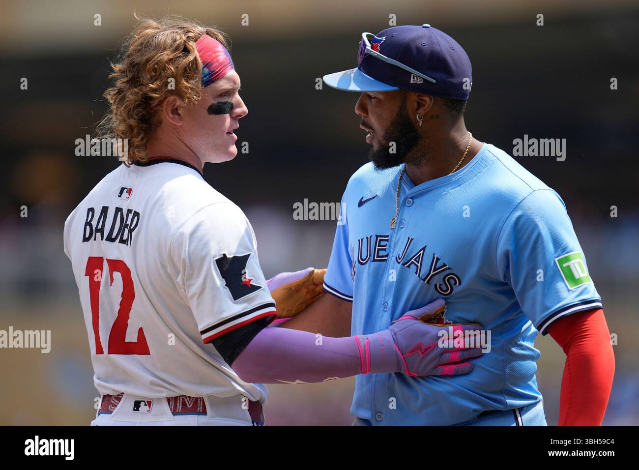 Minnesota Twins' Harrison Bader (12) and Toronto Blue Jays Vladimir ...