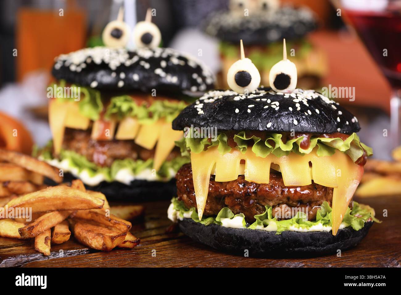 Monster Burger. Black bun, juicy beef cutlet, lettuce, onion, tomato ...