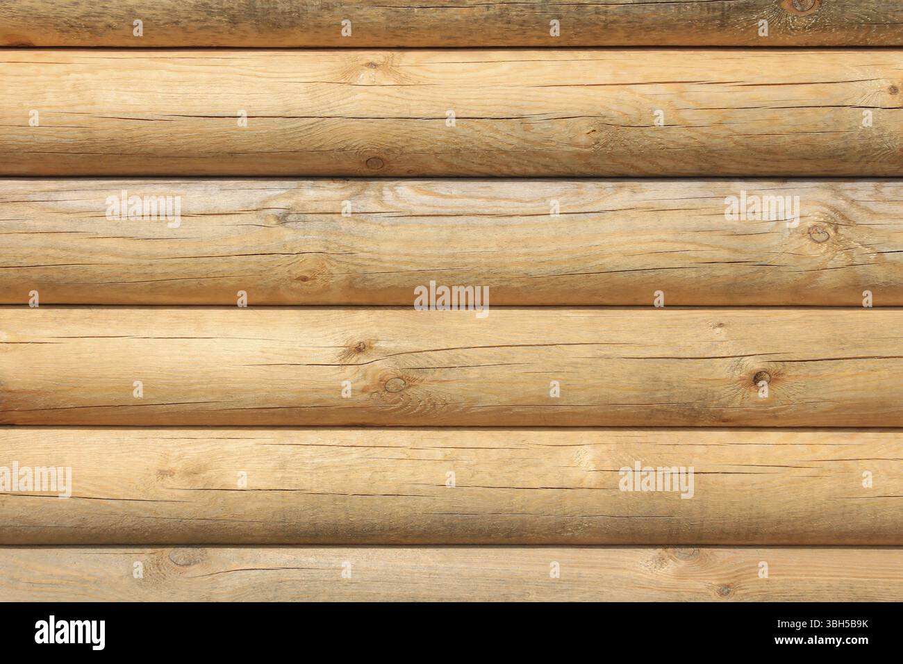 Horizontal parallel large new wooden logs in sunlight, close-up and ...