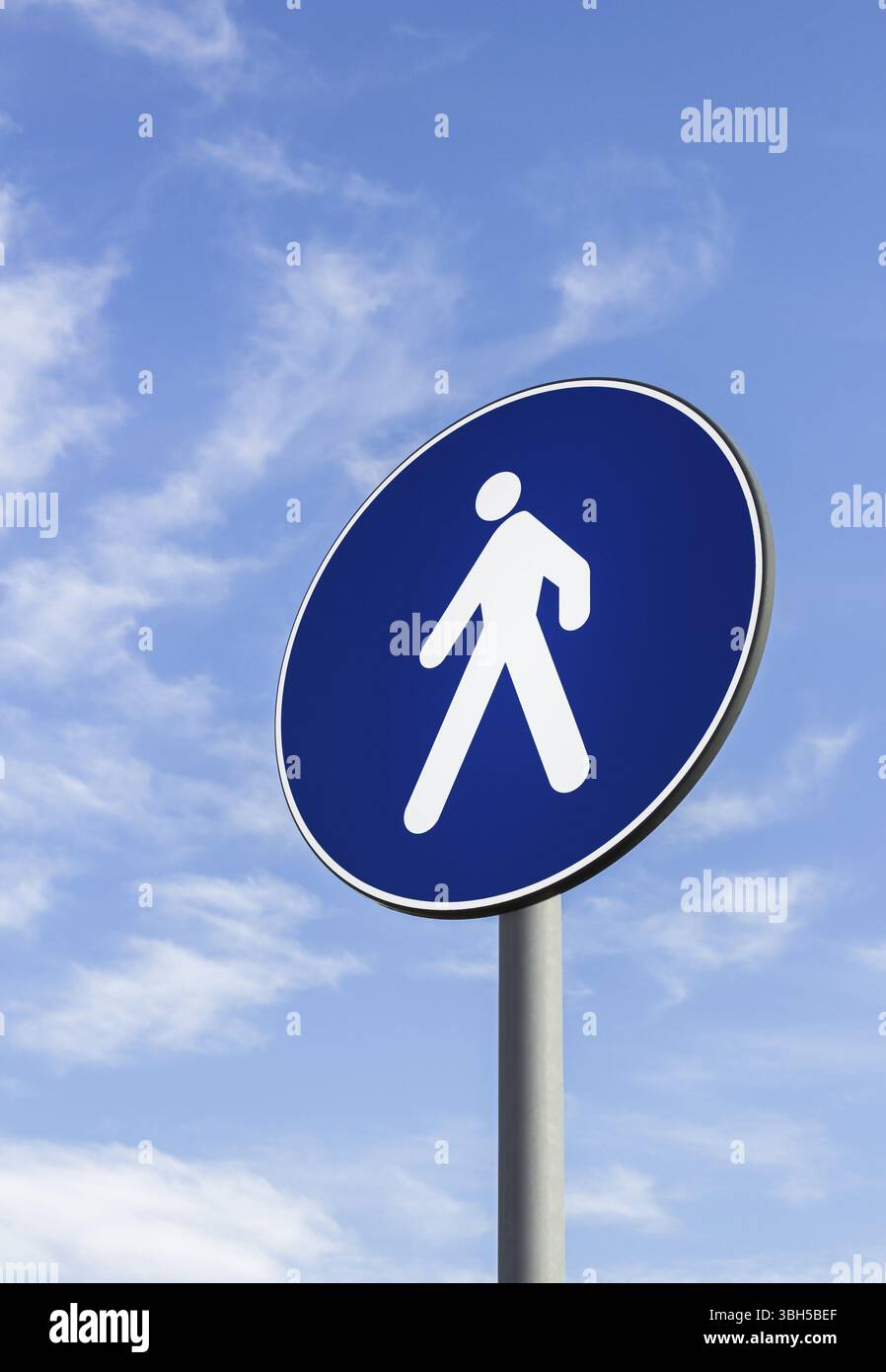 Pedestrian lane road sign on blue sky background Stock Photo - Alamy