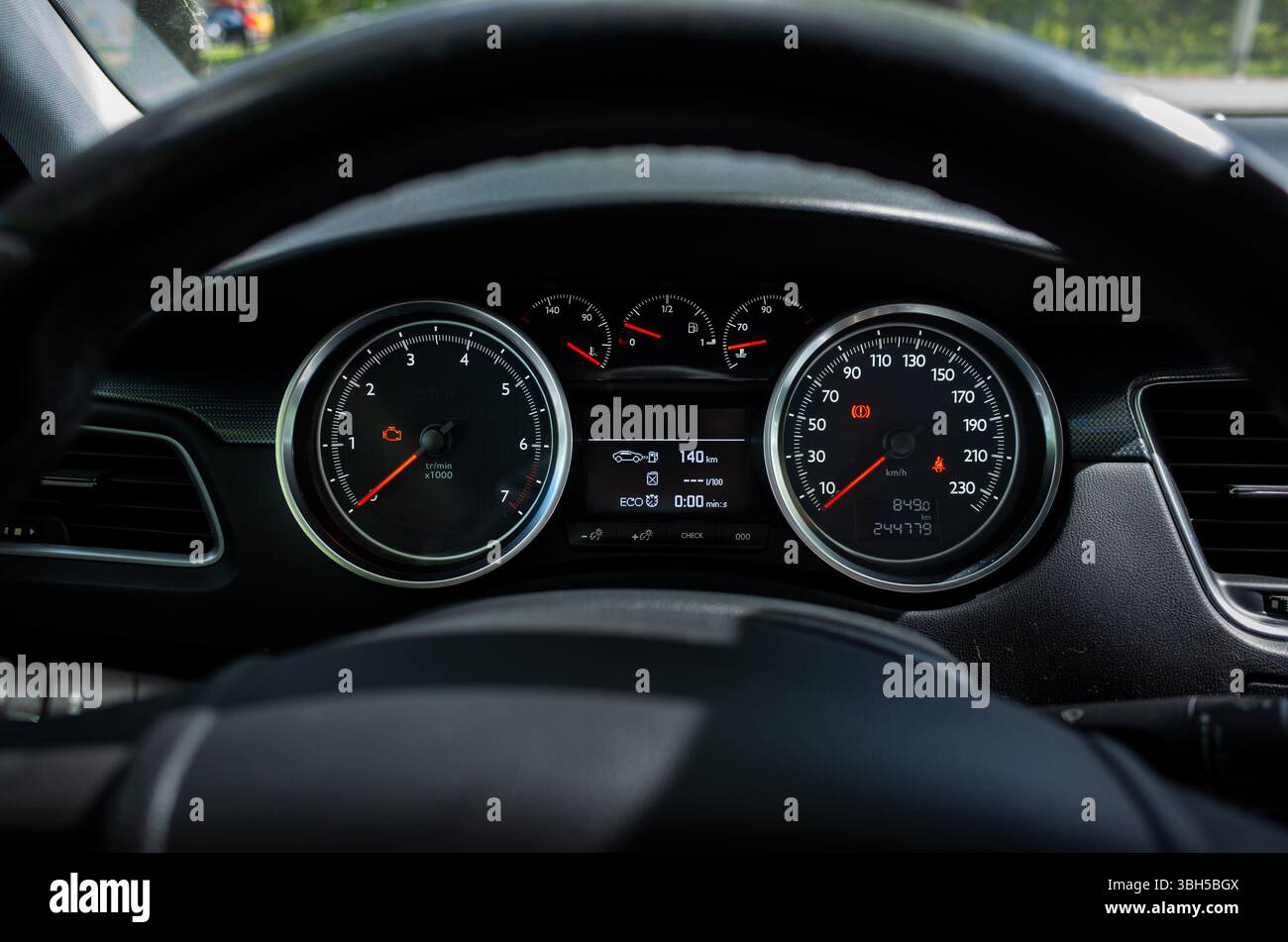 Close up view of a modern car dashboard showing warning lights ...