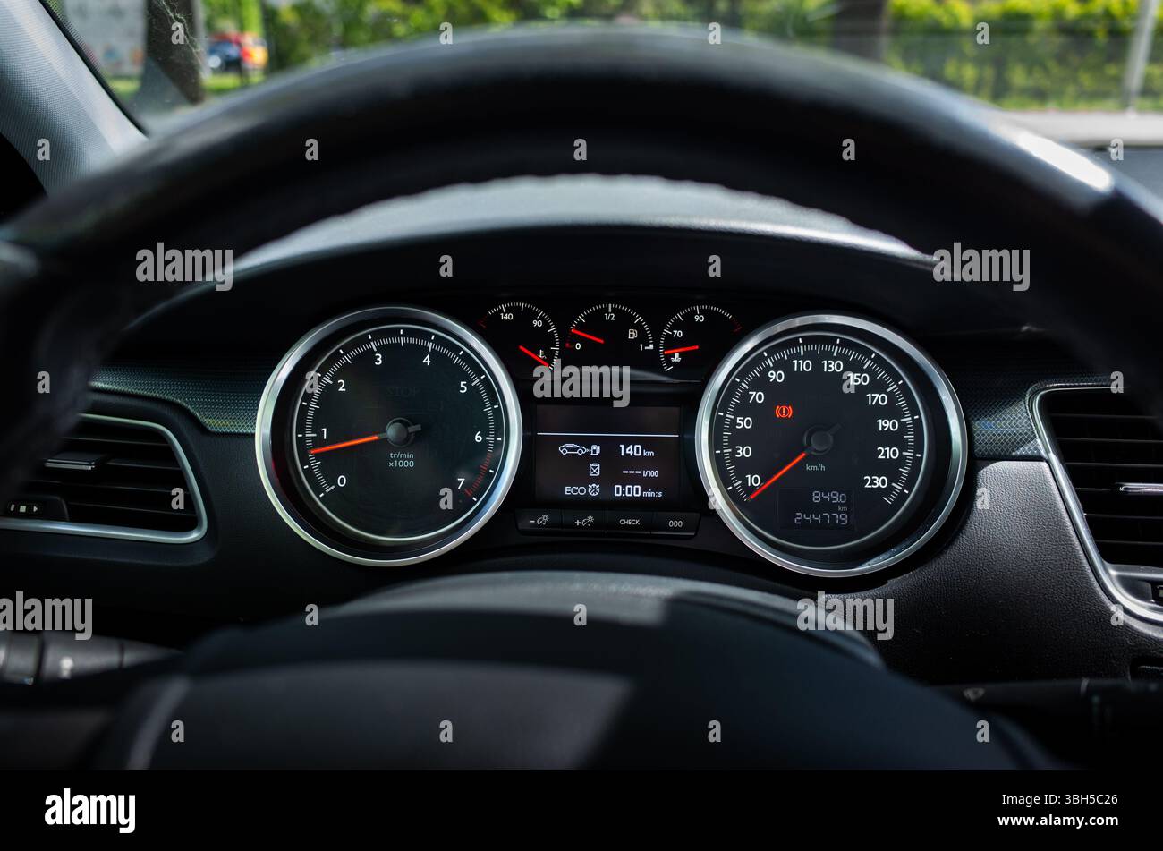 Close up view of a modern car dashboard showing warning lights ...