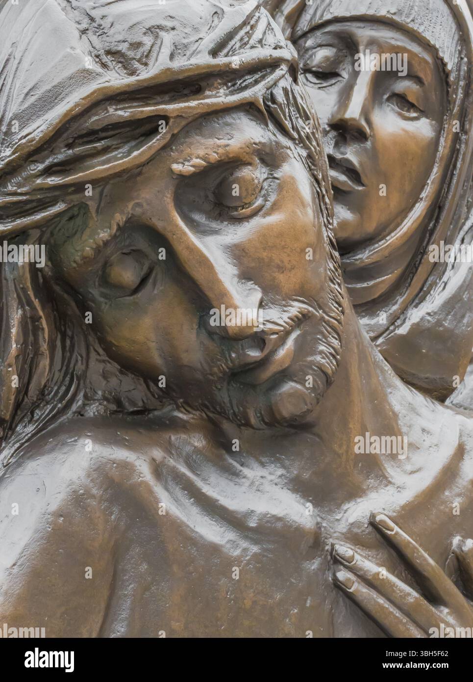 Bronze Statue of dead Jesus Christ down from the cross, being embraced ...
