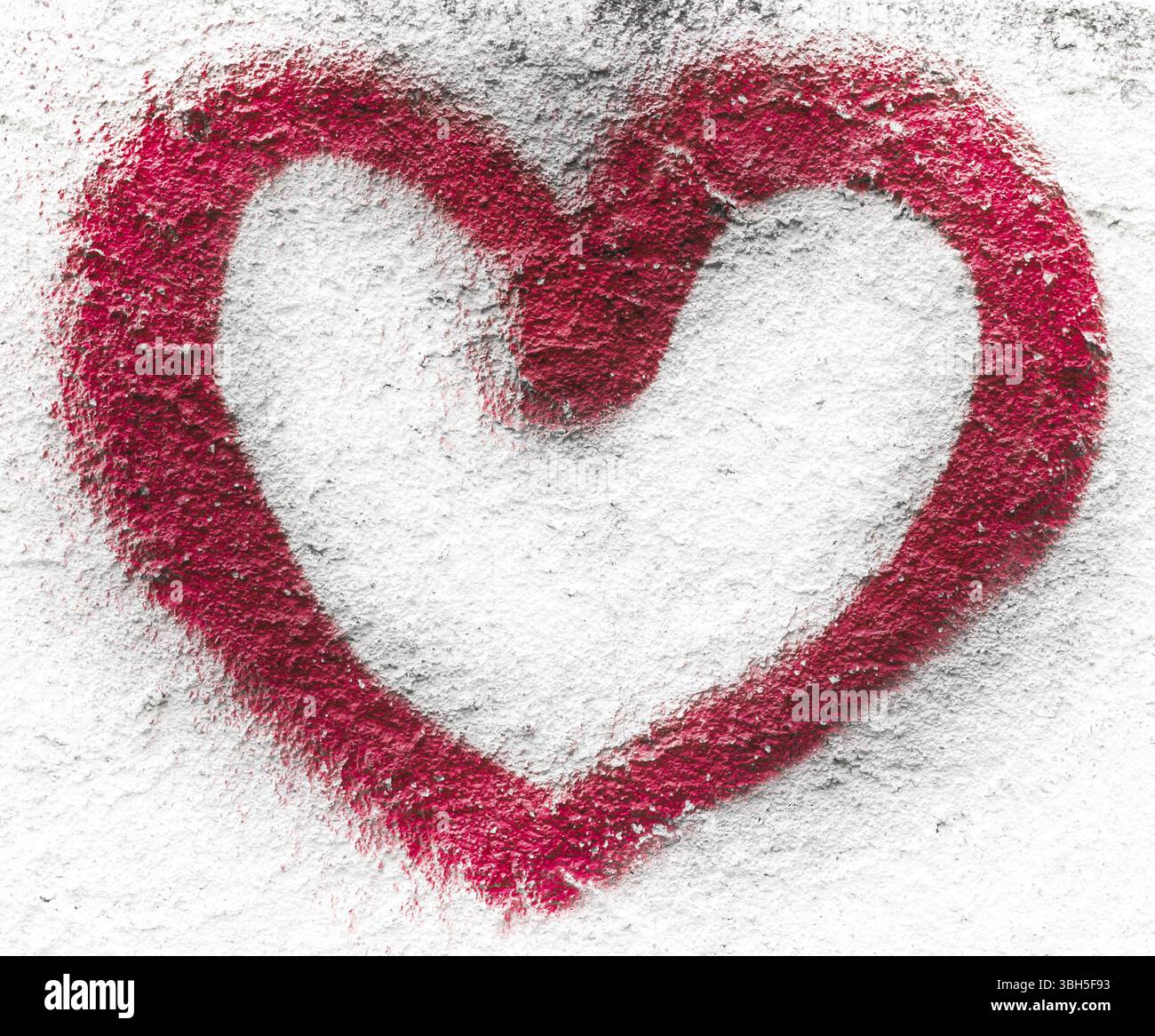 The profile of a red heart, drawn on a wall with spray Stock Photo - Alamy