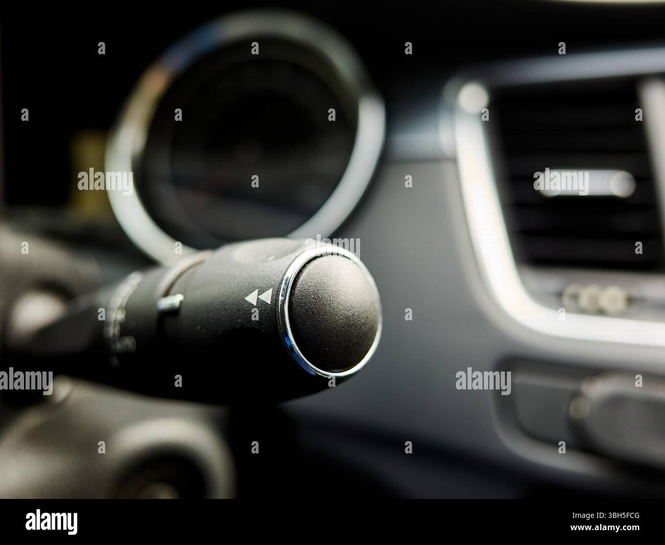 Car's dashboard has a knob that is black and silver. The knob is ...