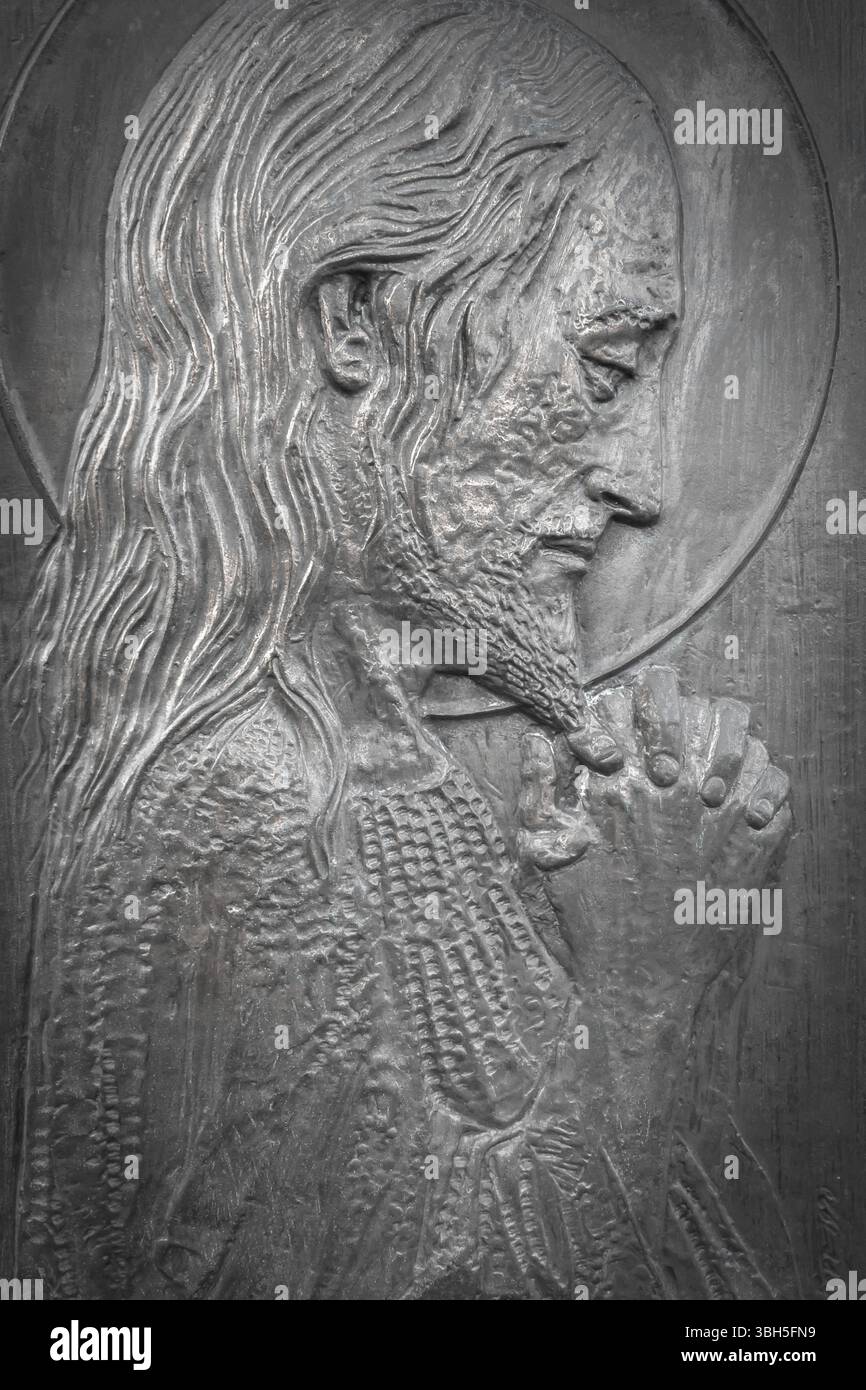 Bas-relief of Jesus with hands clasped. High relief face of Jesus ...