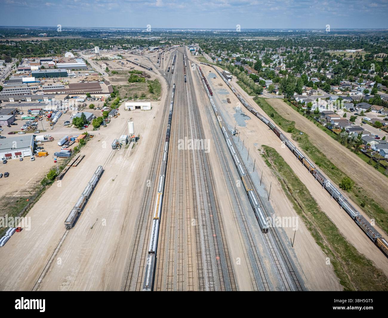 Train track with a lot of trains on it. The train tracks are in a city ...