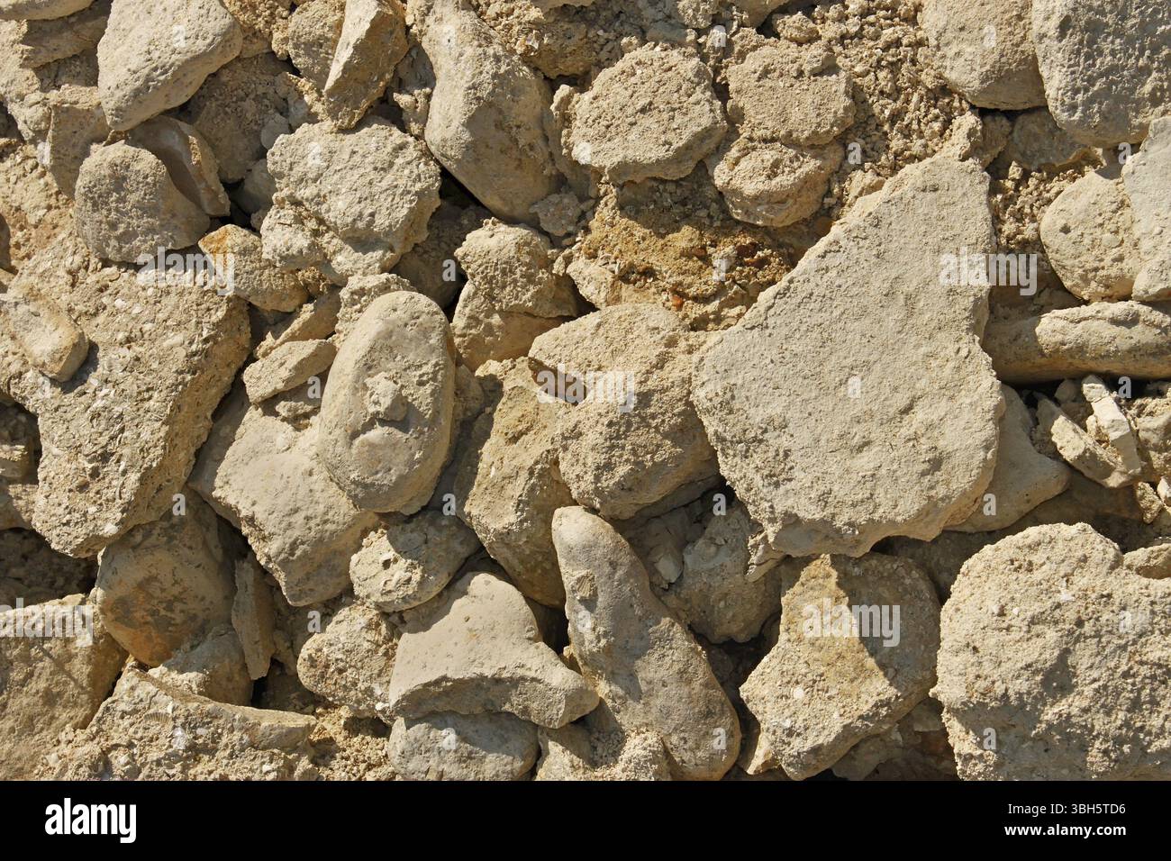 Heap of limestone stones and sand in bright sunlight as a texture Stock ...