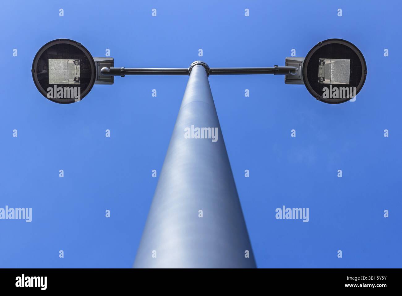Modern electric street light pole over blue sky with clouds. Bottom ...