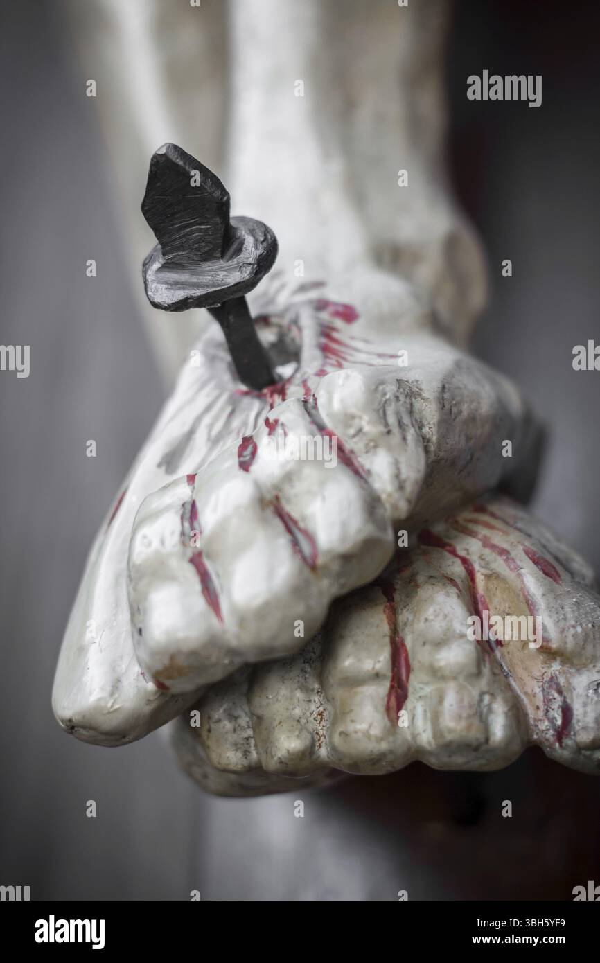 Closeup of feet of Jesus Christ nailed to the cross during the ...