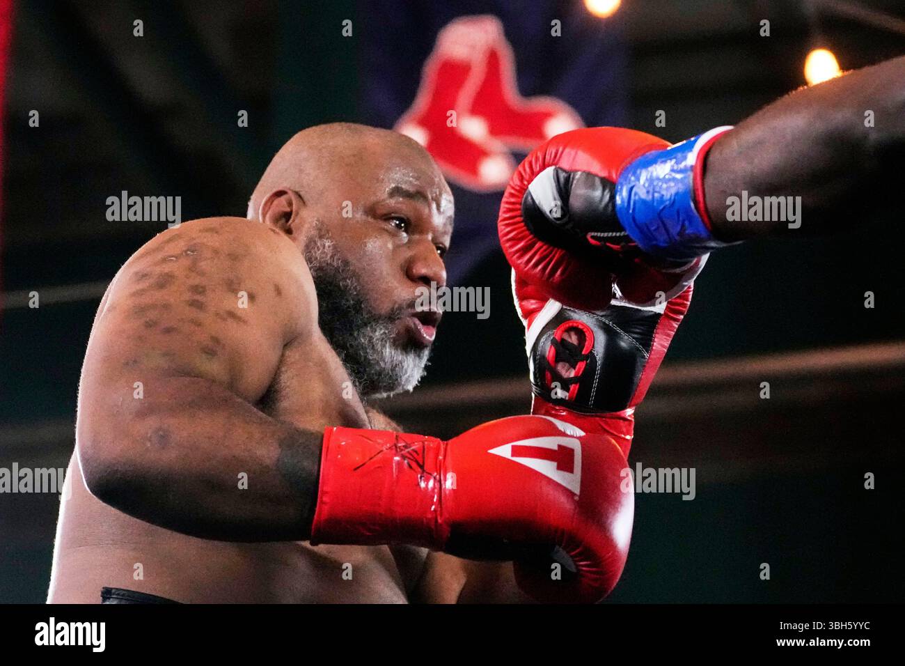 Tracey Johnson, of Boston, dodges a punch from Harold Roy during a ...
