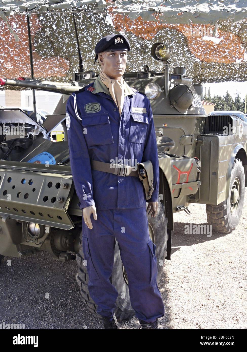 A small armoured military vehicle with a doll in a typical uniform ...