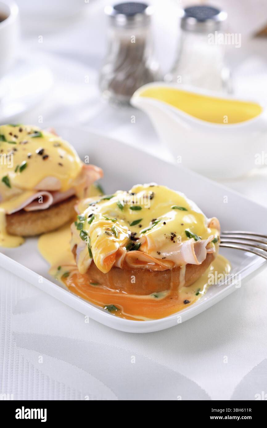 Breakfast. Best Eggs Benedict - fried English bun, ham, poached eggs ...