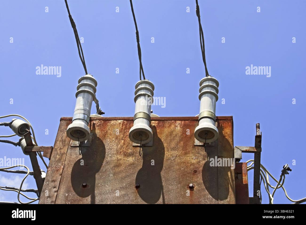 Electric insulators and wires on the old three-phase electrical ...