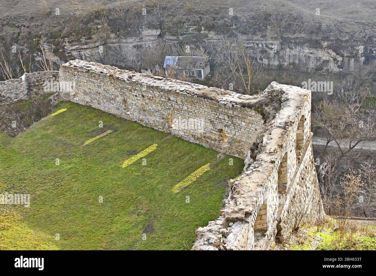 Fragment of ancient walls of the medieval fortress above the canyon in ...