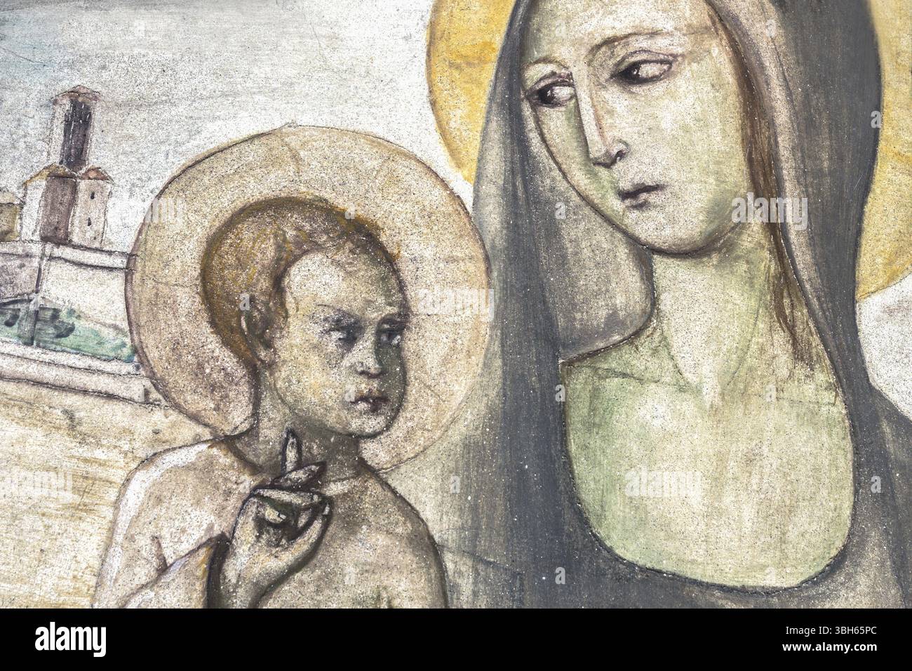 Ancient fresco with faded colors wich represents the Virgin Mary with ...