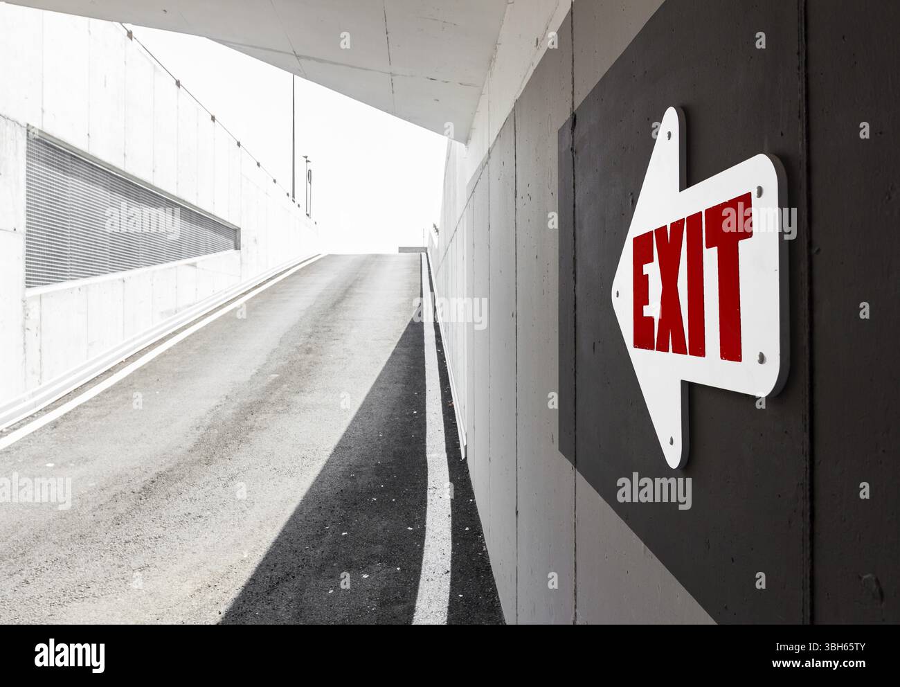 Underground parking garage exit with arrow signal Stock Photo - Alamy