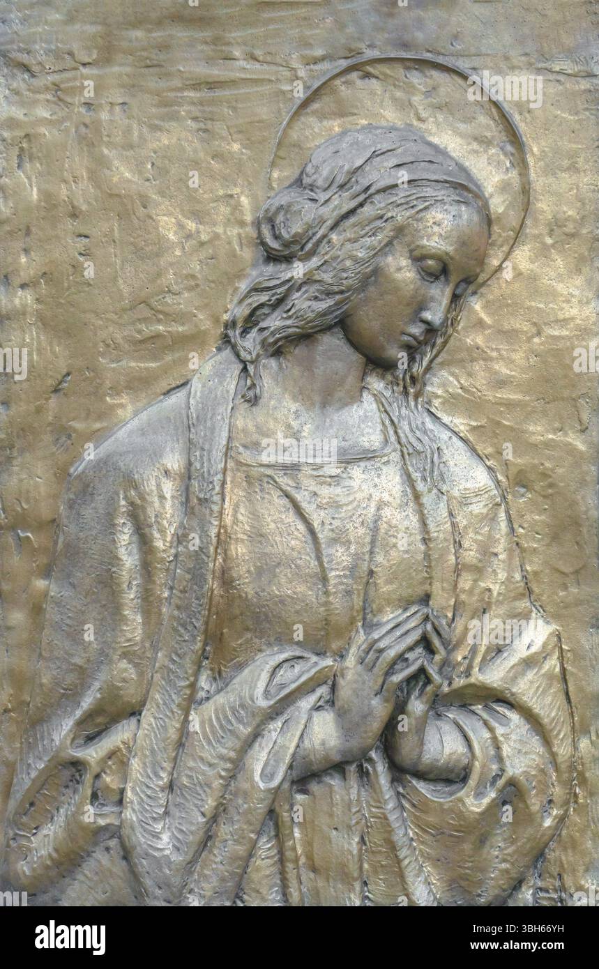 Bronze bas-relief of the Virgin Mary. Loss of the son Jesus. Sadness ...