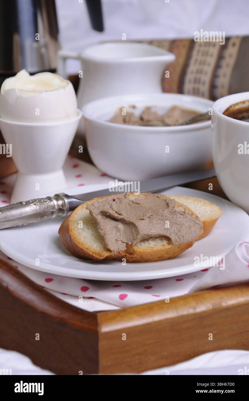 A slice of toast spread with liver pate for breakfast on a tray Stock ...