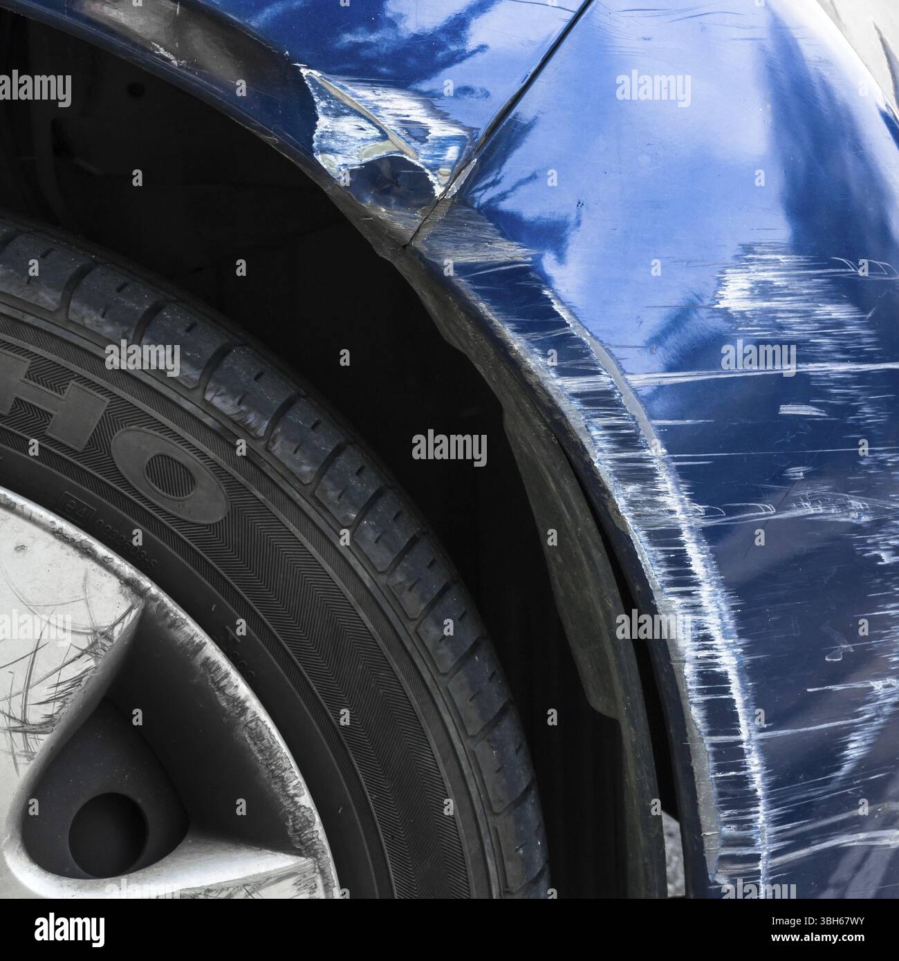 Accident damage to the front side of a blue car Stock Photo - Alamy