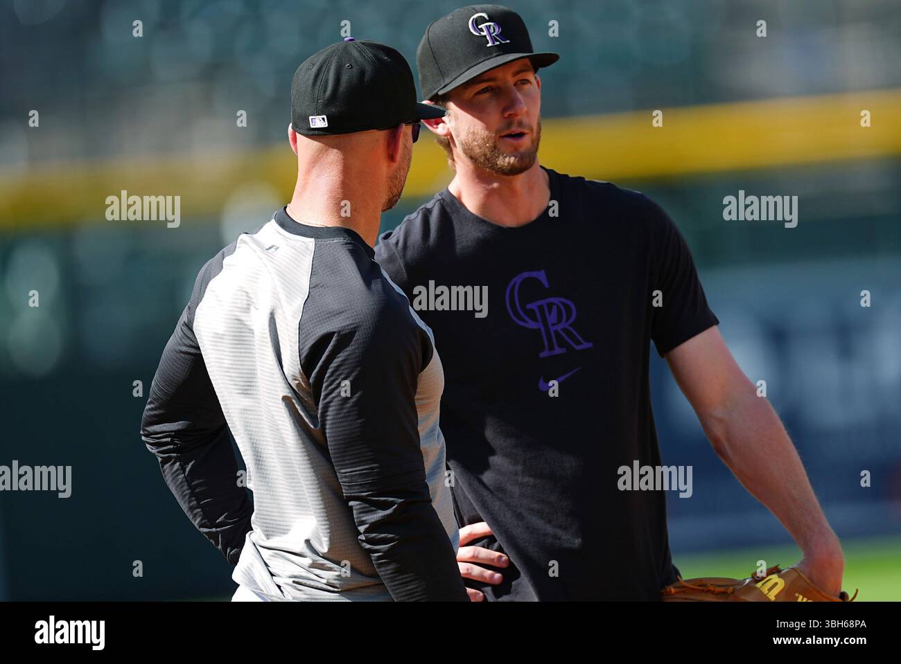 Colorado Rockies third baseman Ryan McMahon, right, chats with interim ...
