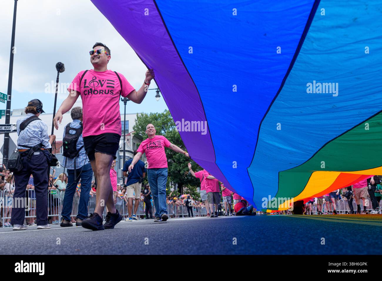 Washington, United States. 07th June, 2025. People hold a giant pride ...
